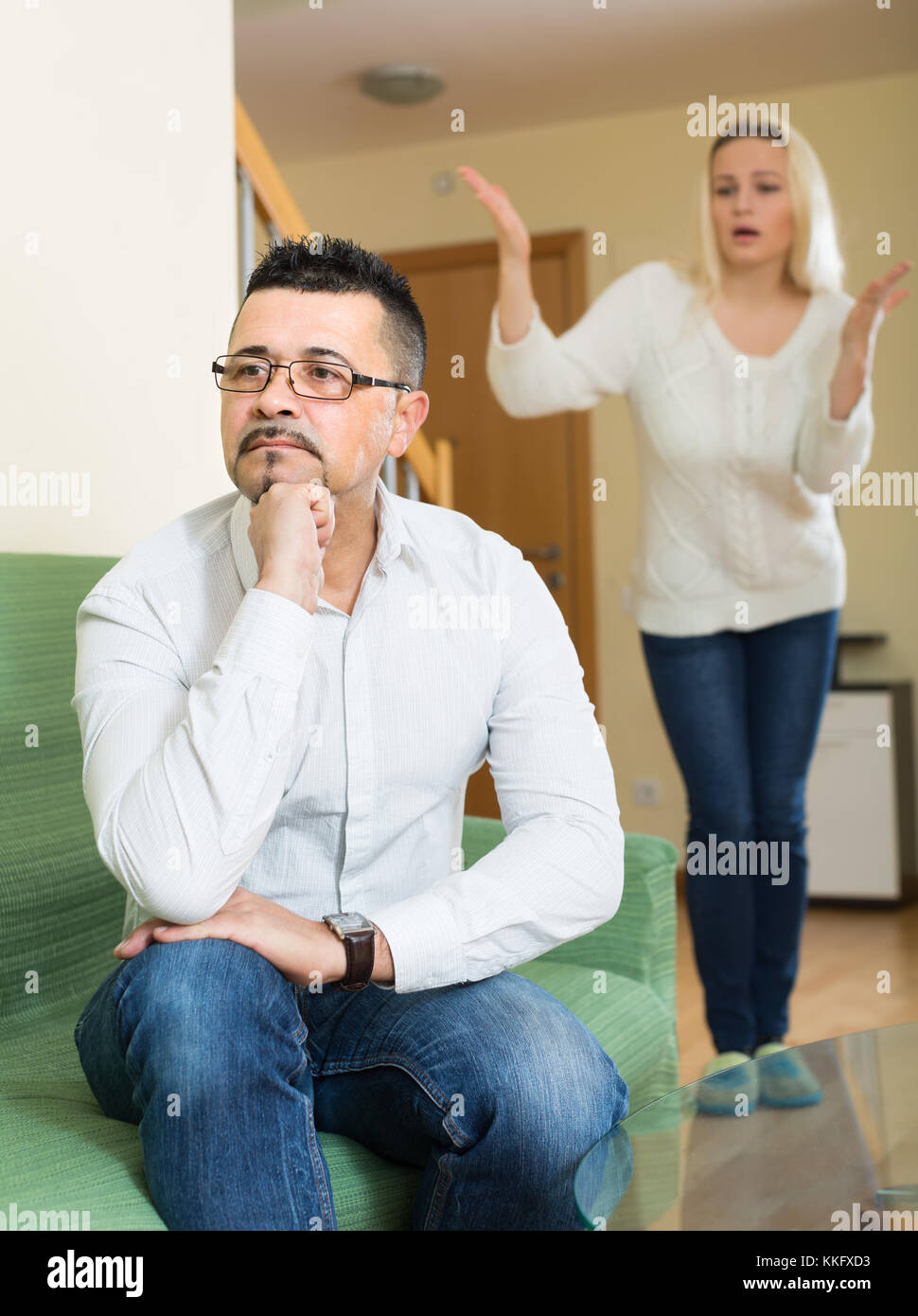 Family quarrel. Man and angry woman during quarrel in living room at ...