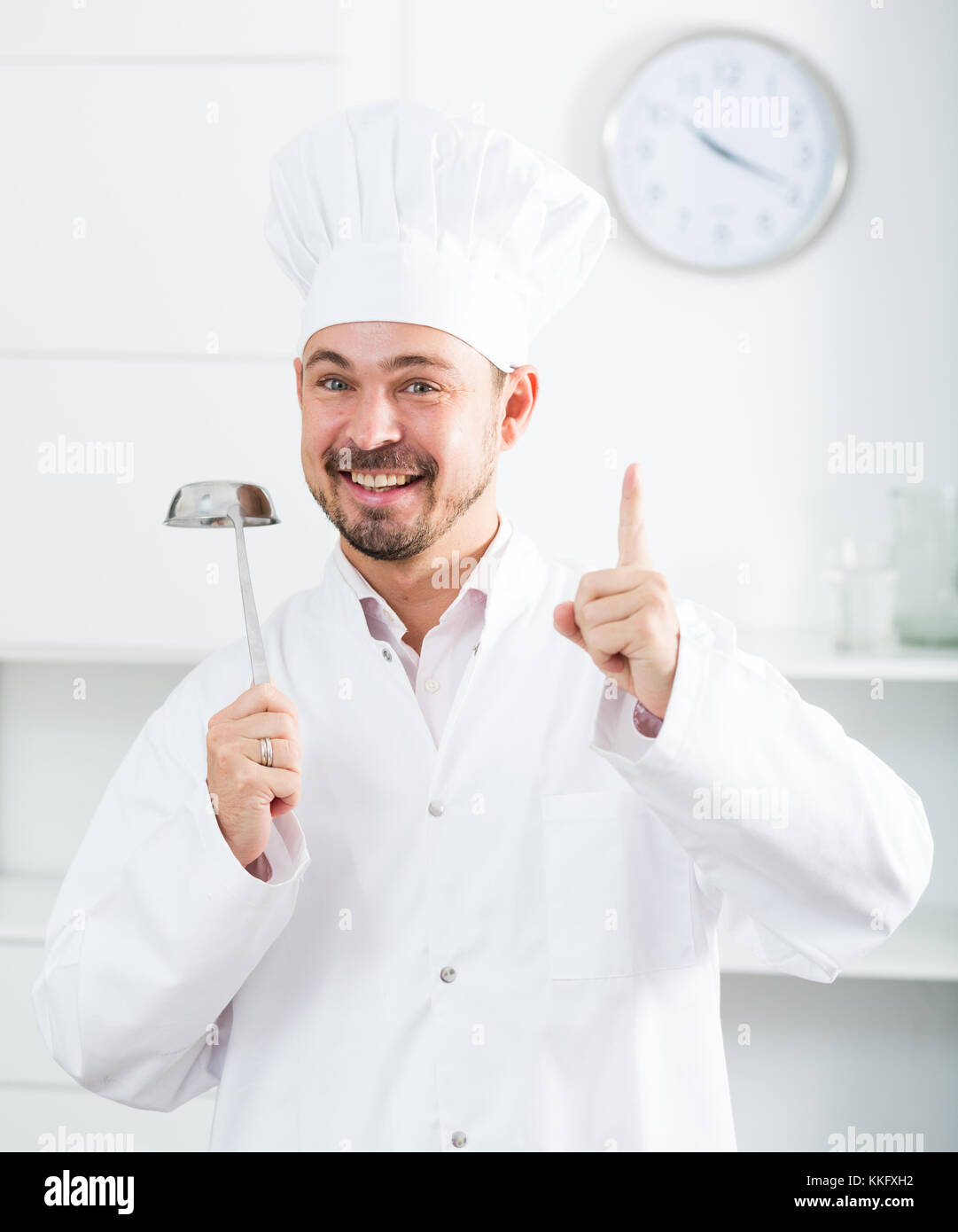 Portrait of smiling young chief showing his soup ladle Stock Photo - Alamy