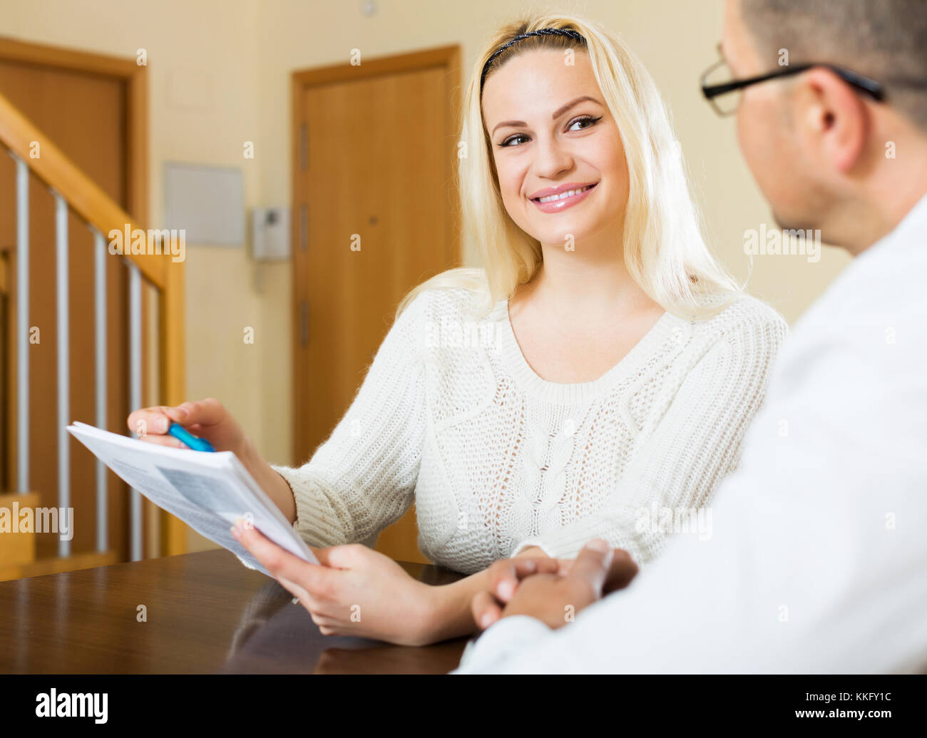 Smiling couple filling questionnaire for employee with laptop of the ...