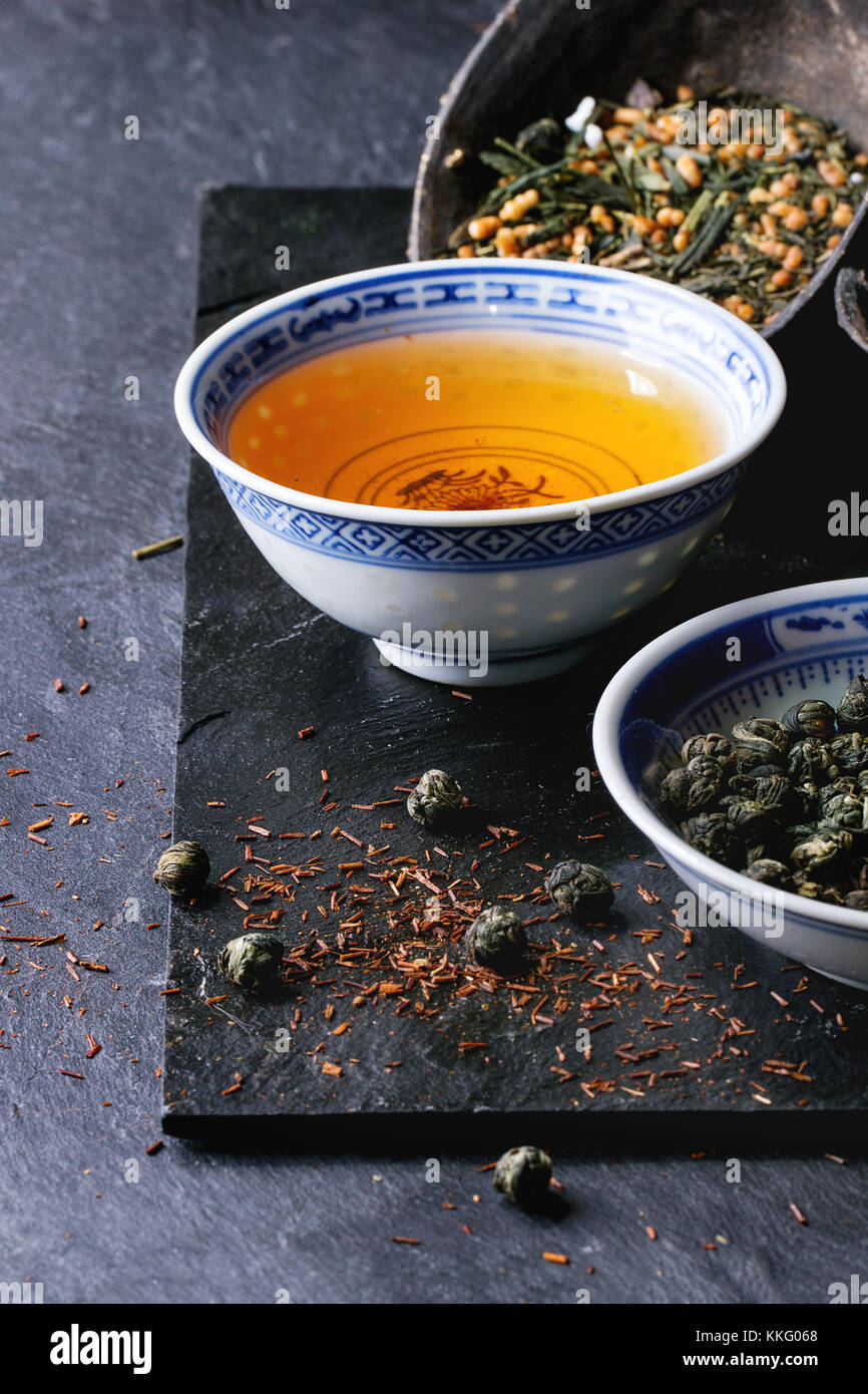 Assortment of dry tea and cup of hot tea. Green tea, black tae, green ...