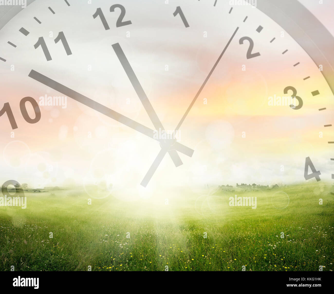 Clock face in sky above field Stock Photo - Alamy