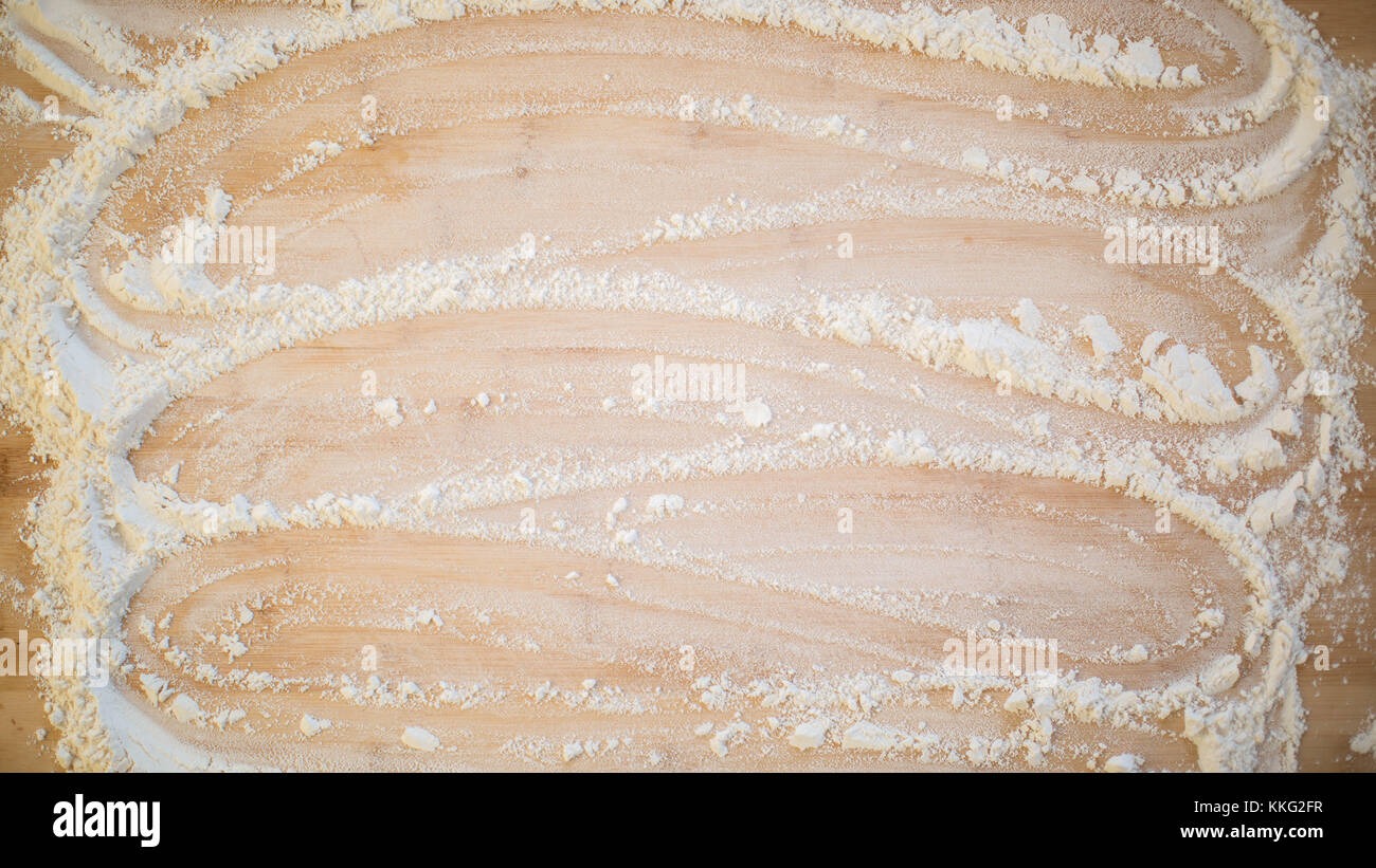 Flour spread across a wooden cutting board in a diagonal pattern Stock ...