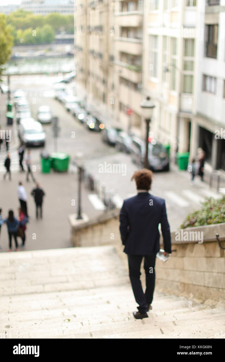 Handsome mix blood man walking down steps with newspaper Stock Photo ...