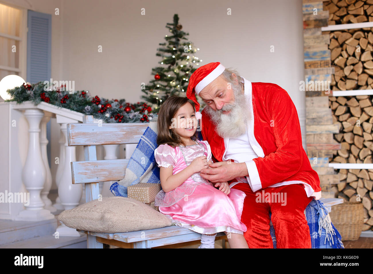Joyous Santa Claus speaking with little princess Stock Photo - Alamy