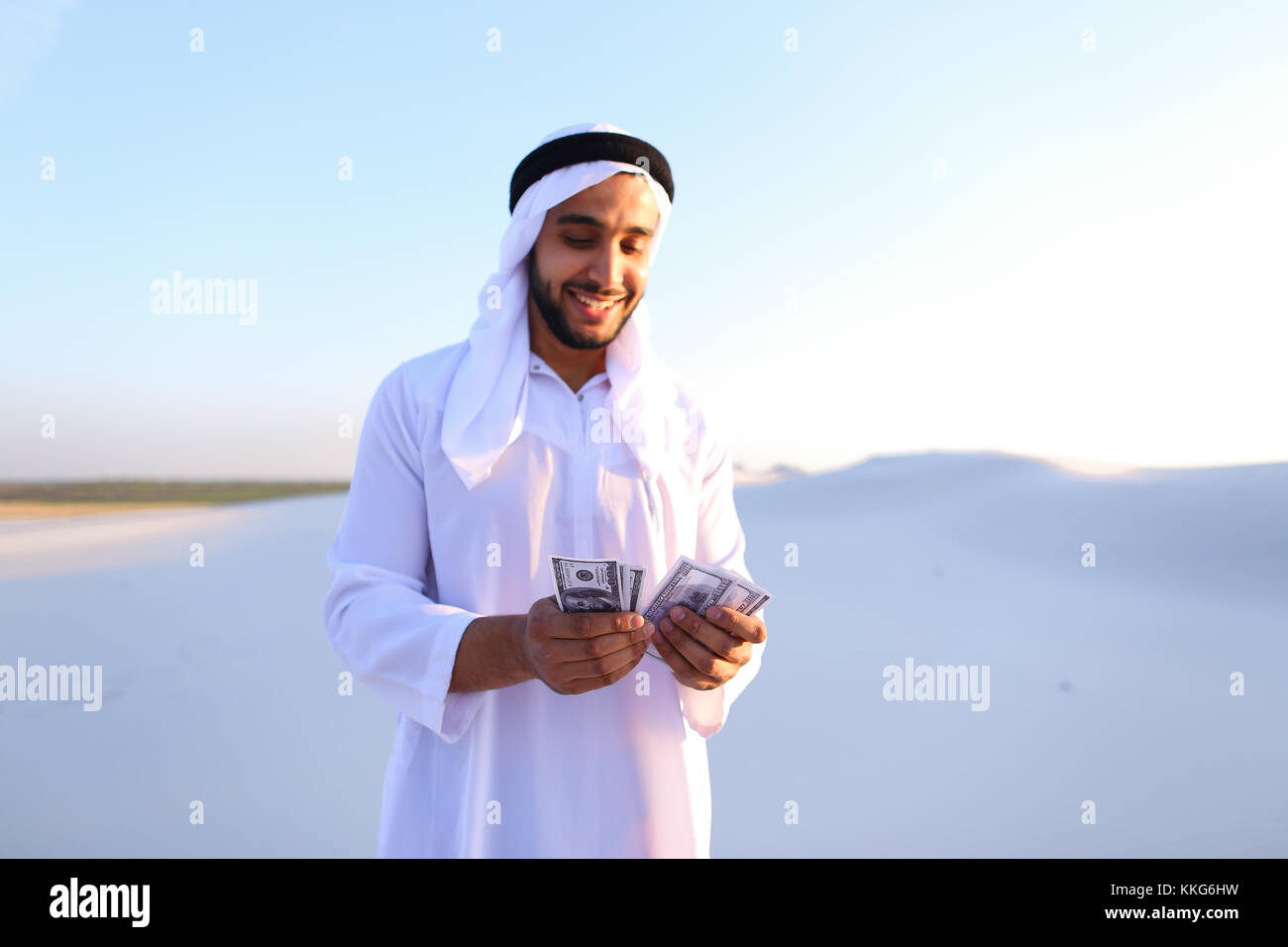 Successful Arab sheikh considers banknotes and happy, standing i Stock ...