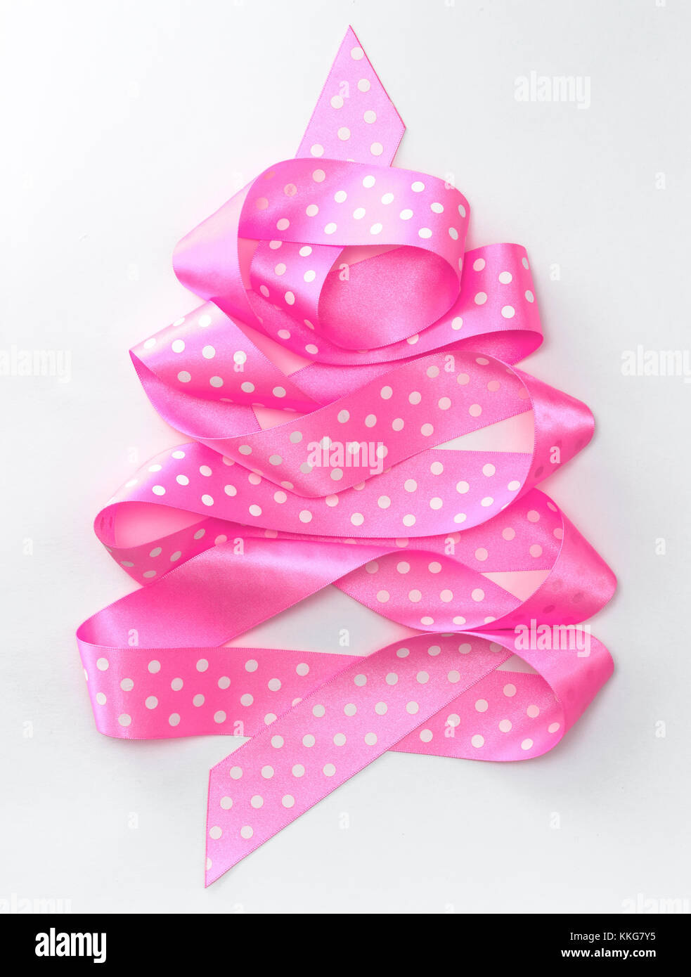 Christmas tree from pink ribbon tape isolated on a white background ...