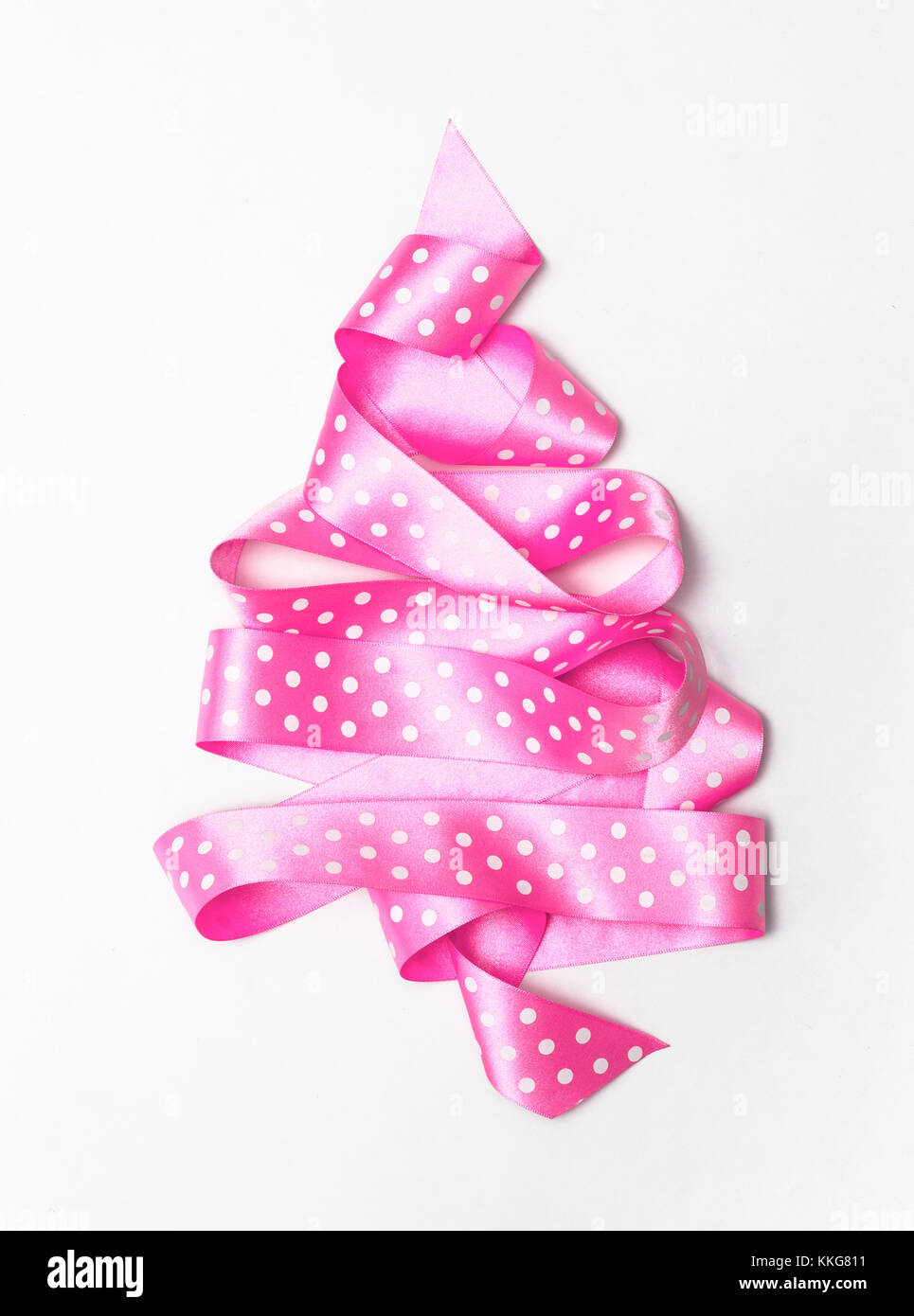 Christmas tree from pink ribbon tape isolated on a white background ...