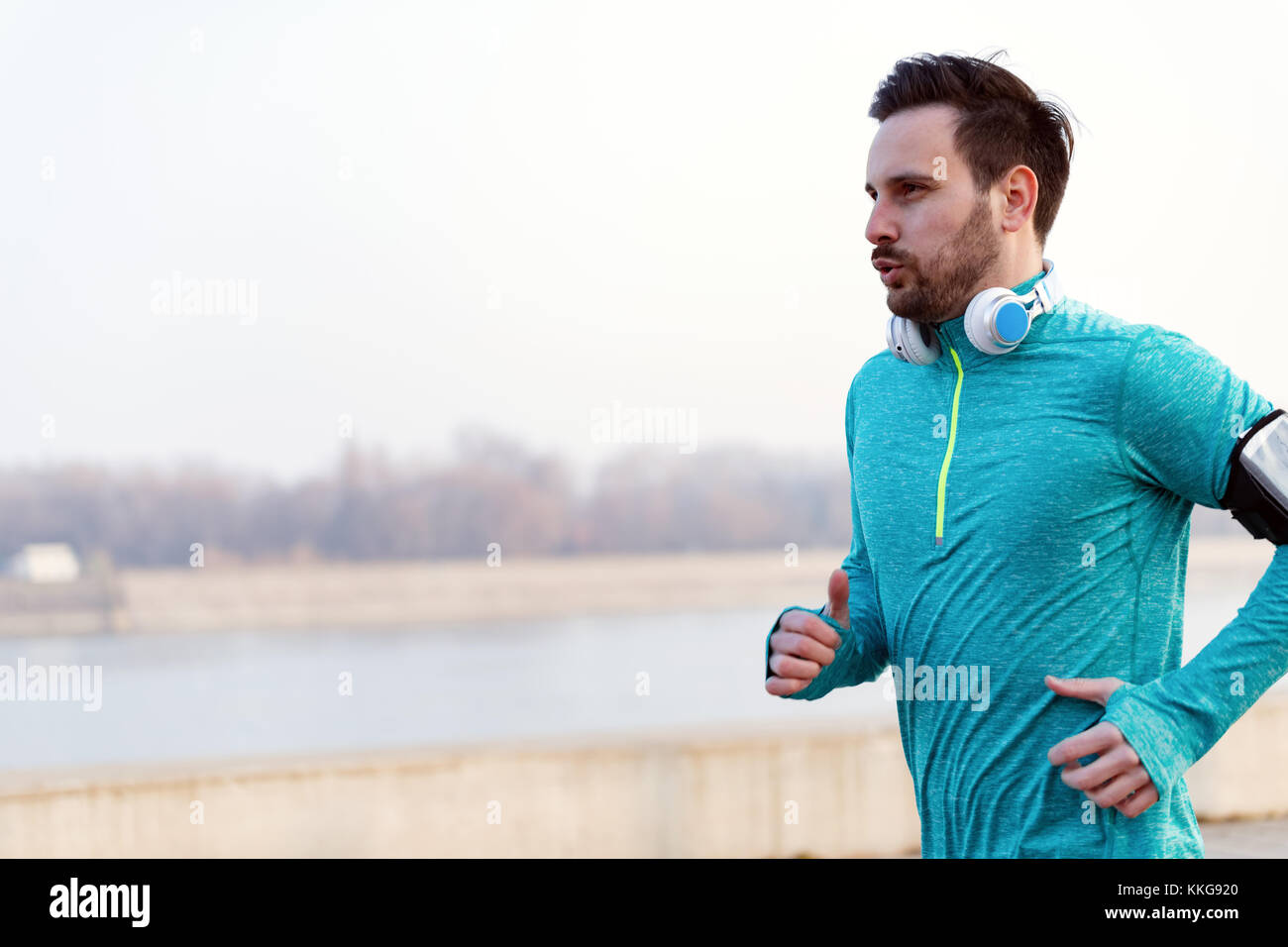 Young fitness man running in urban area Stock Photo - Alamy