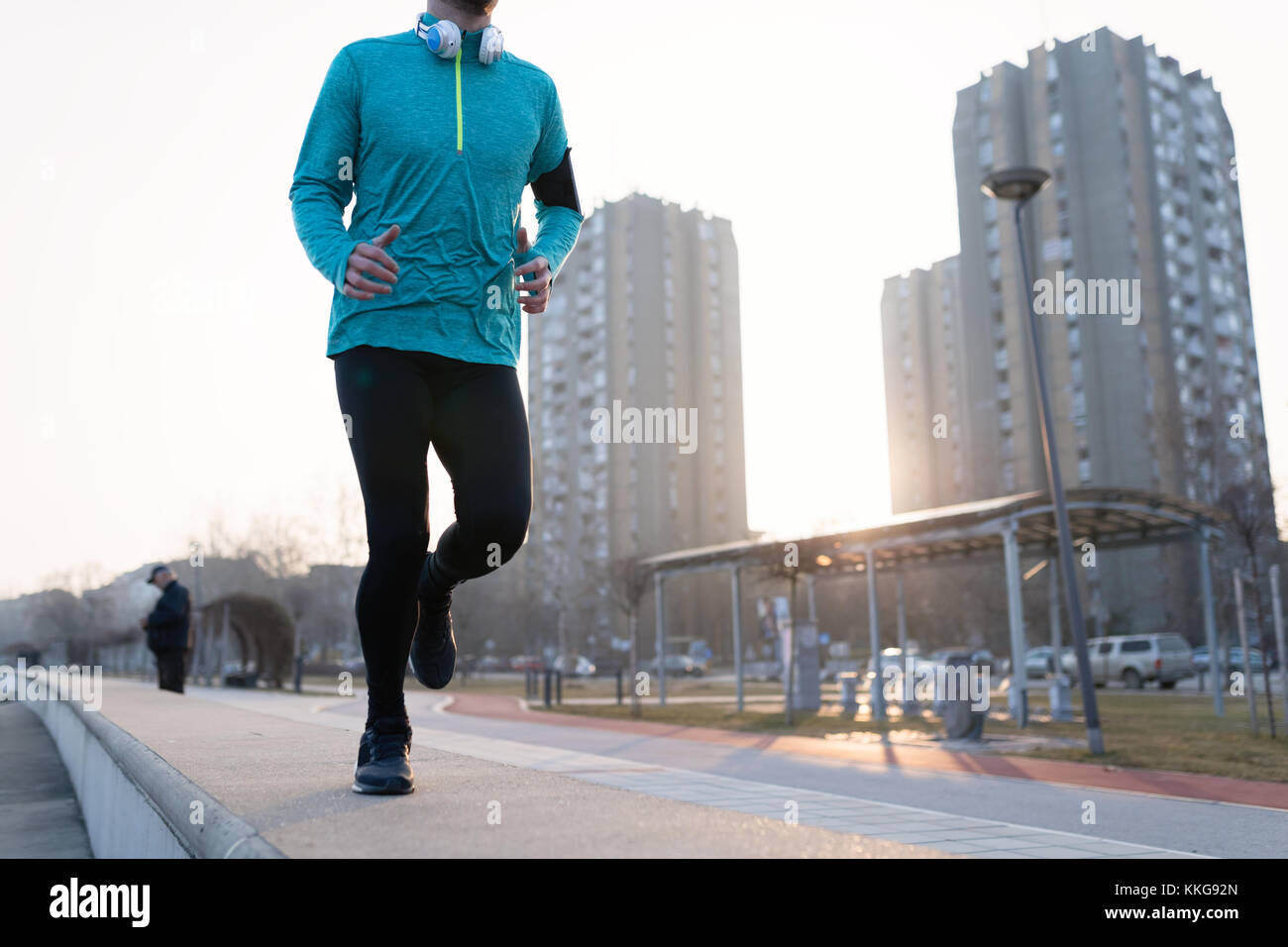 Young fitness man running in urban area Stock Photo - Alamy