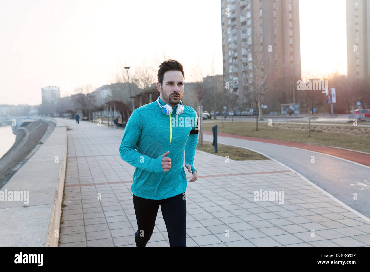 Young fitness man running in urban area Stock Photo - Alamy