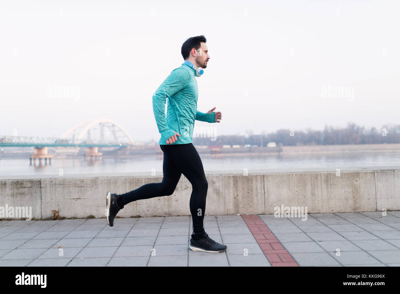 Young fitness man running in urban area Stock Photo - Alamy