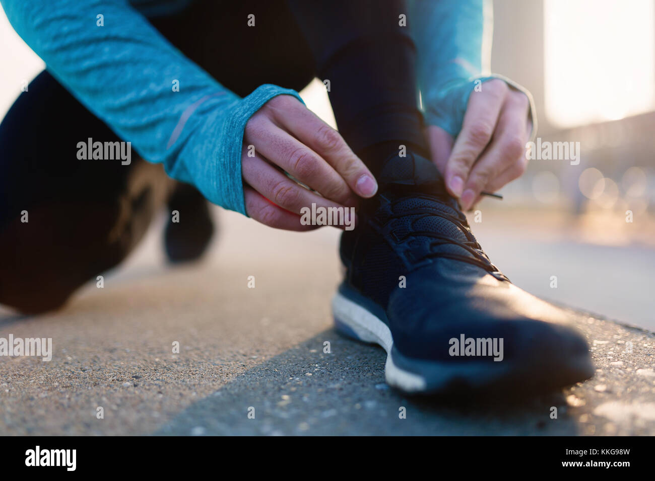 Runner trying running shoes getting ready for run Stock Photo - Alamy