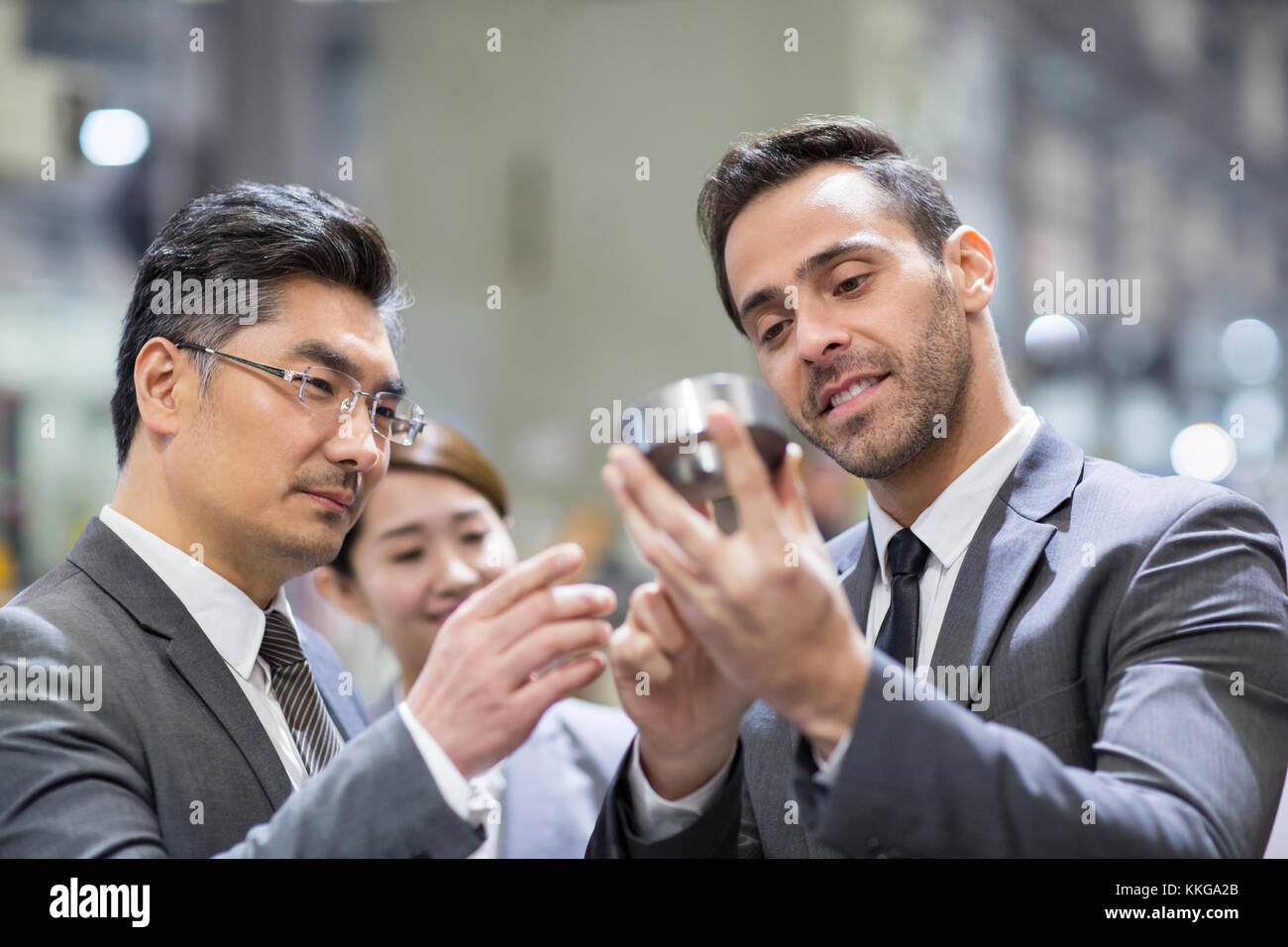 Business people checking machine parts in the factory Stock Photo - Alamy