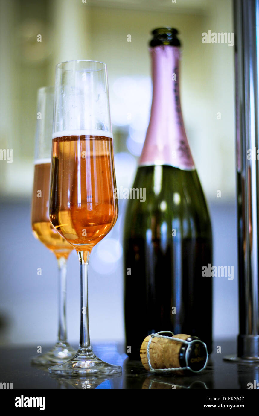 Two filled glasses and a bottle Stock Photo - Alamy