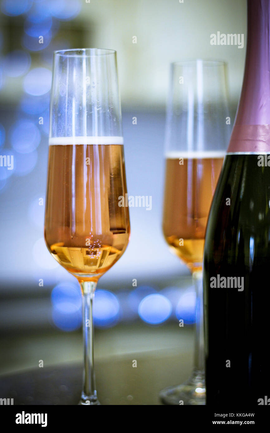 Two filled glasses and a bottle Stock Photo - Alamy