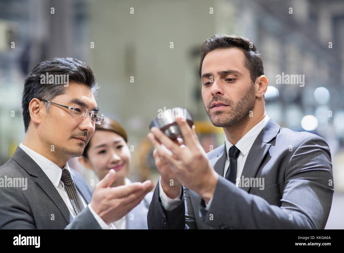 Business people checking machine parts in the factory Stock Photo - Alamy