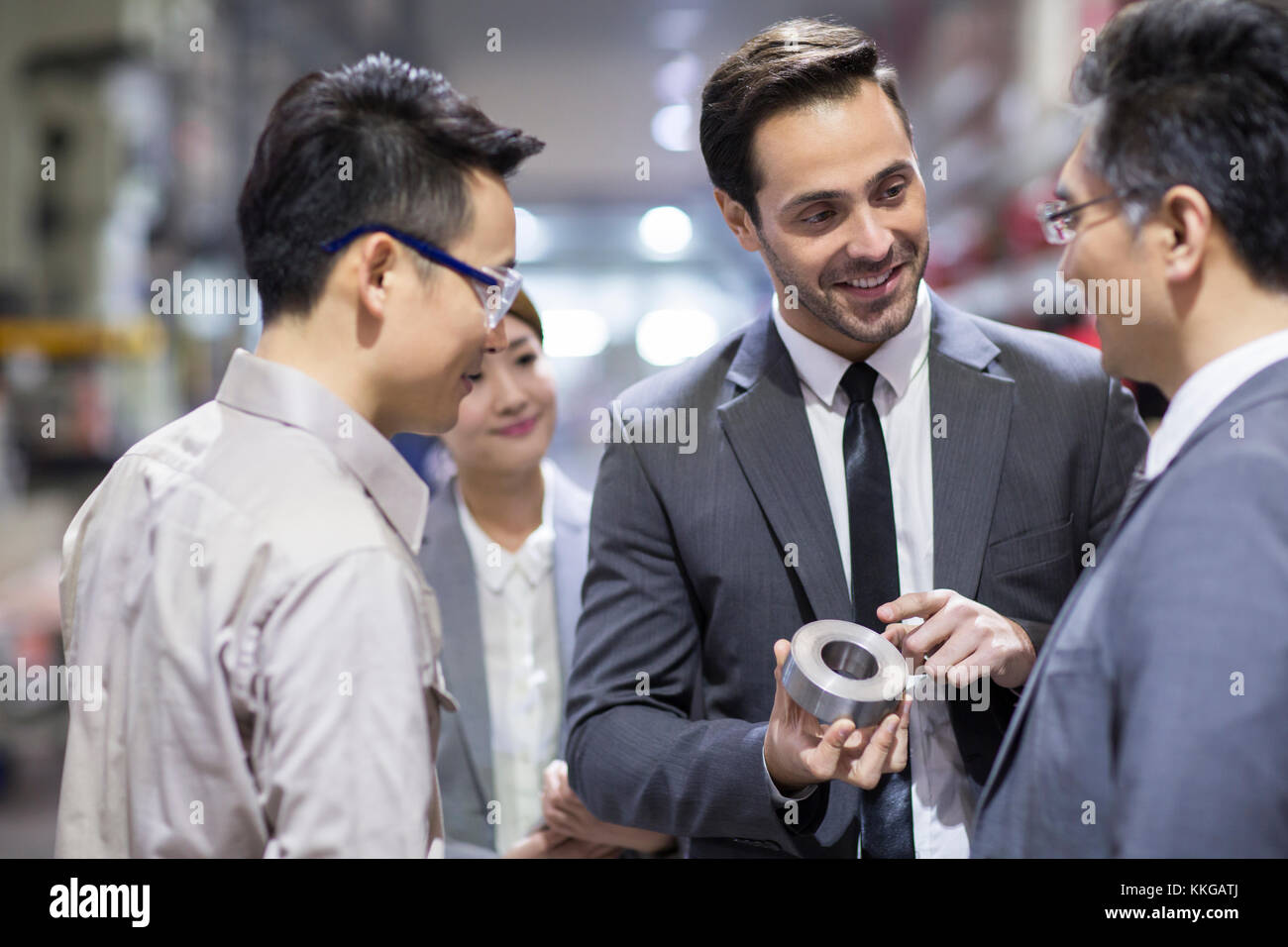 Businessmen and engineers checking machine parts in the factory Stock ...