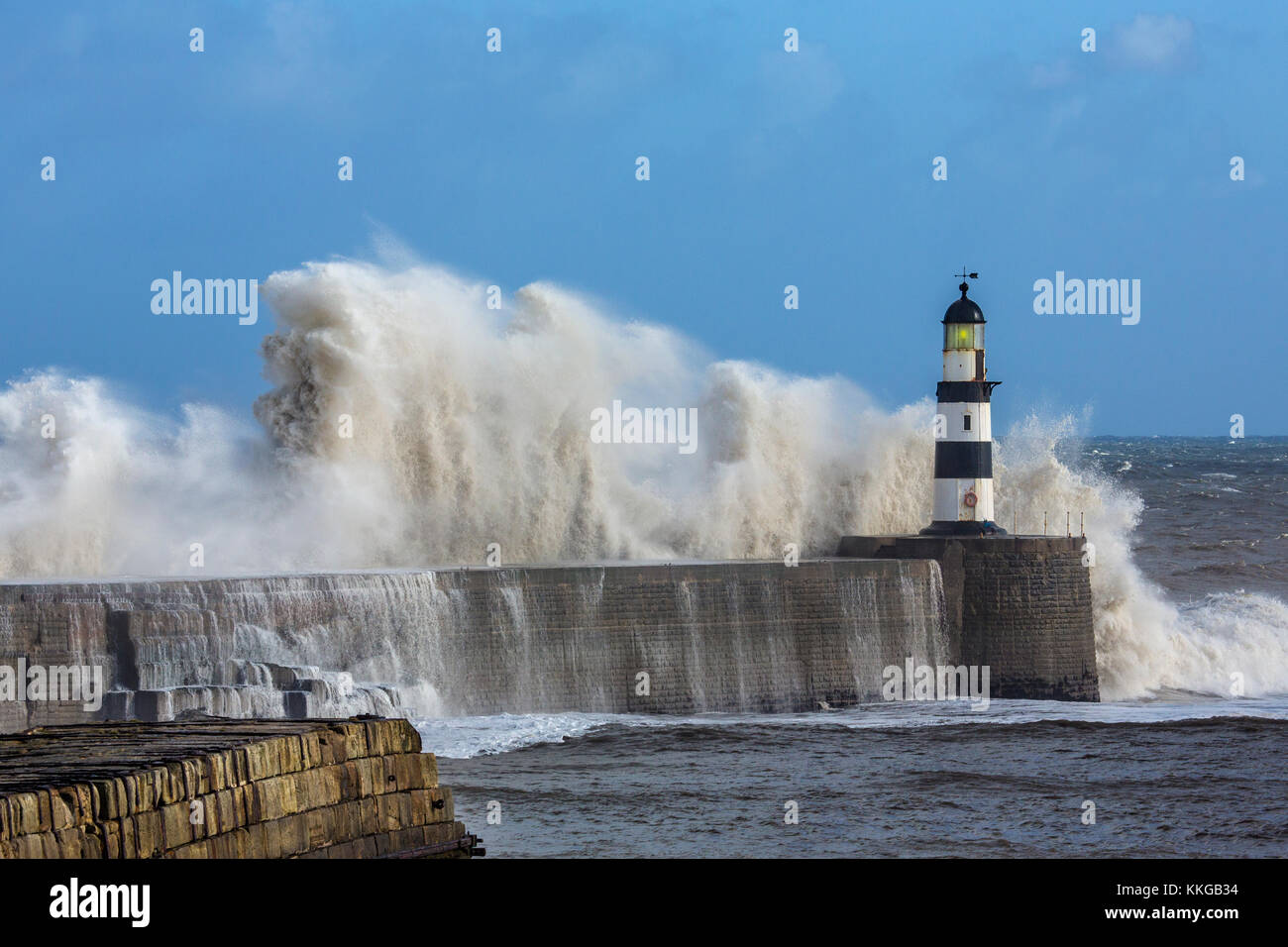 Waves crashing over Seaham Lighthouse on the northeast coast of England ...
