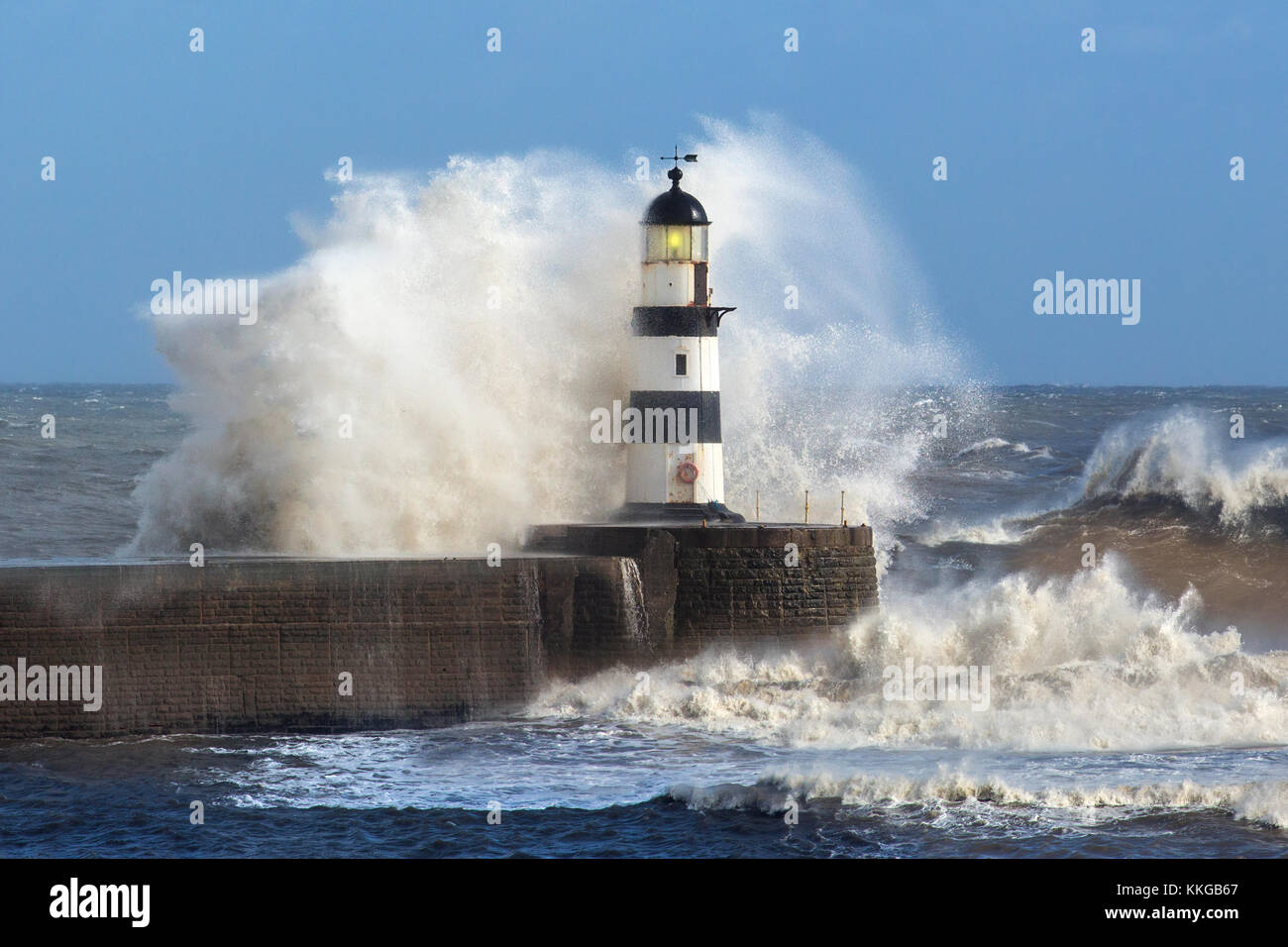 Waves crashing over Seaham Lighthouse on the northeast coast of England ...