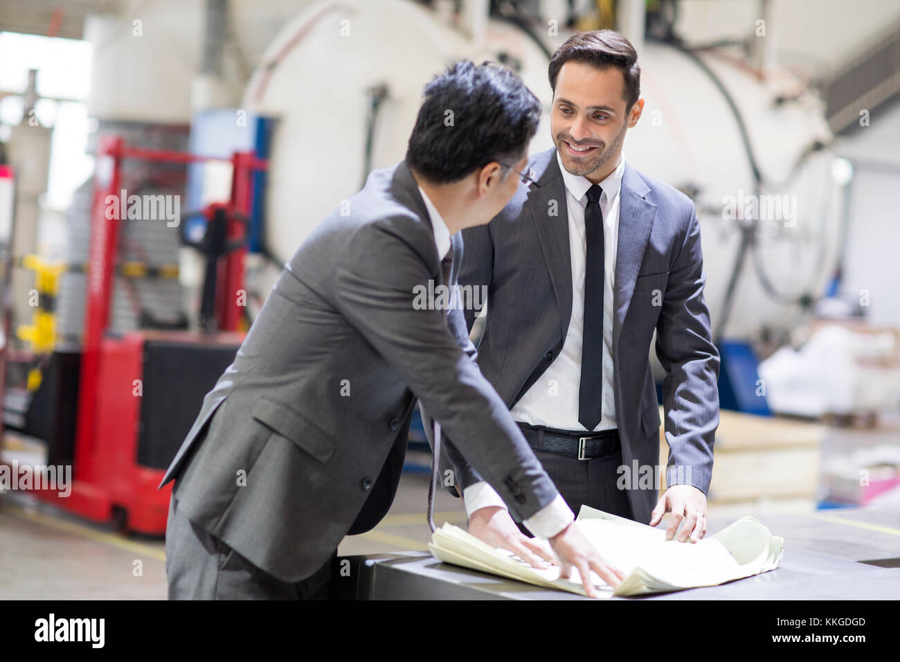 Businessman and engineer talking in the factory Stock Photo - Alamy