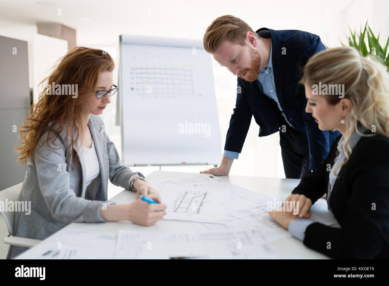 Team of architects working together on project Stock Photo - Alamy