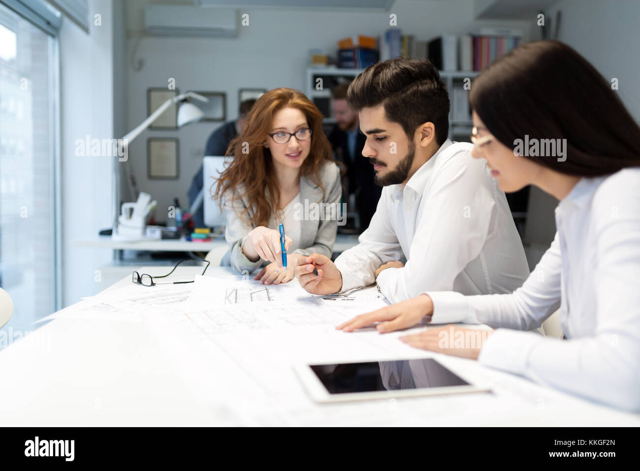 Team of architects working together on project Stock Photo - Alamy