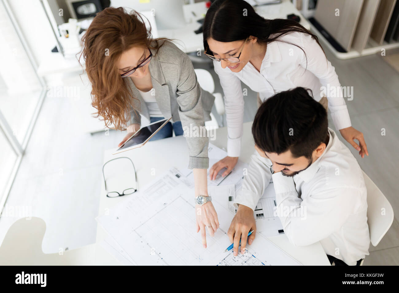 Team of architects working together on project Stock Photo - Alamy