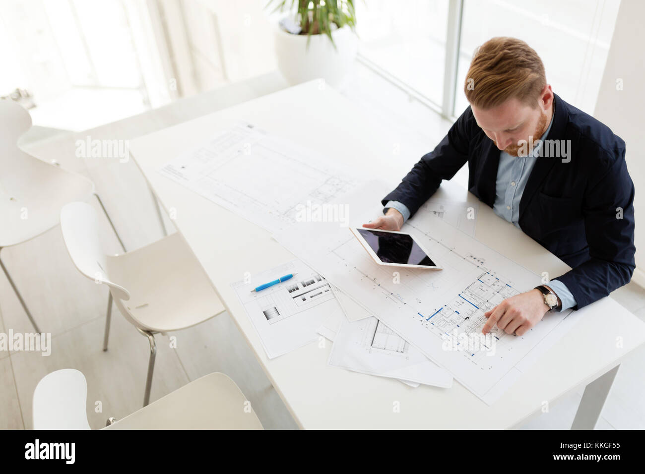 Young male architect working on project in office Stock Photo - Alamy