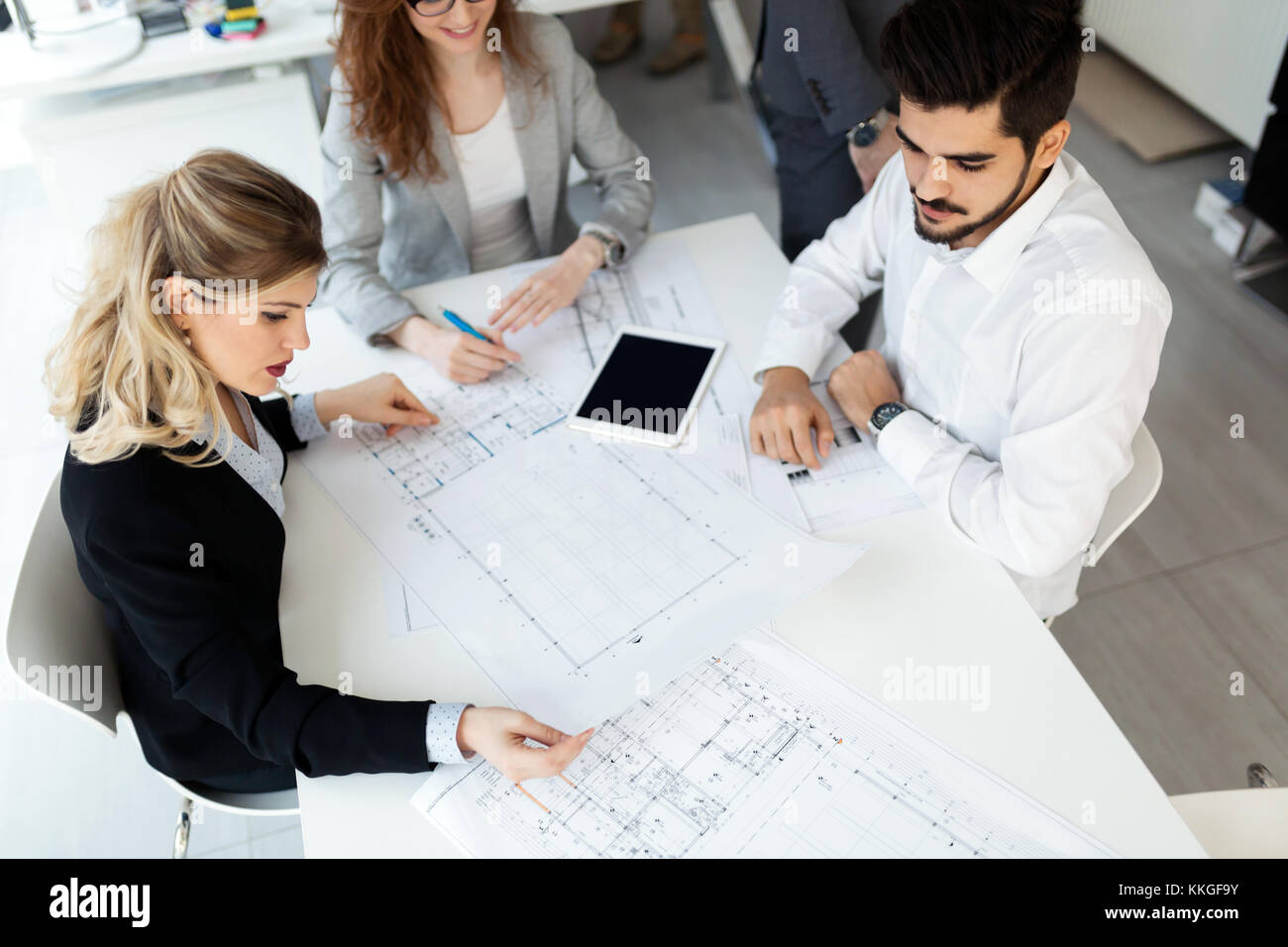 Team of architects working together on project Stock Photo - Alamy