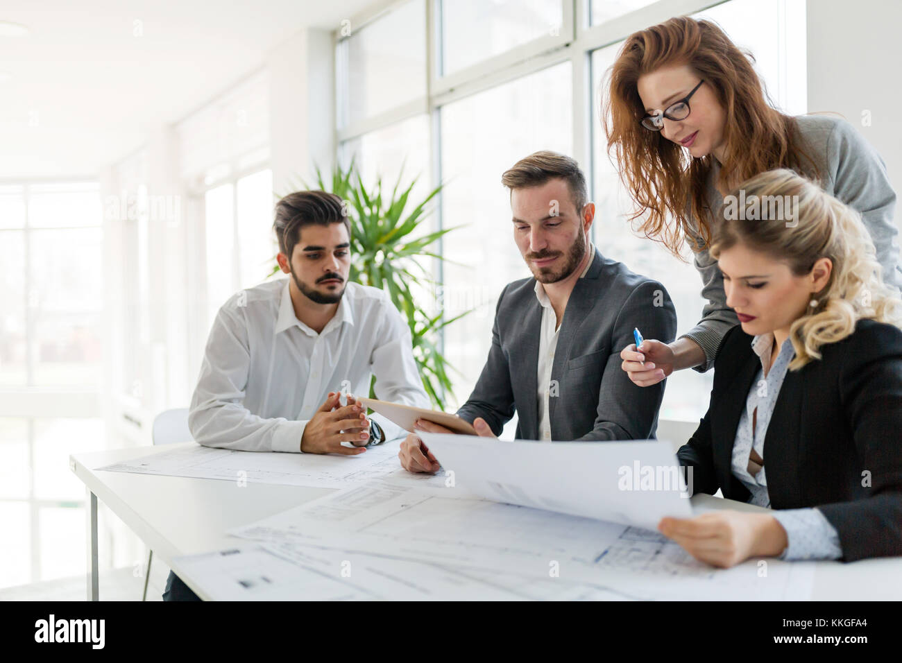 Team of architects working together on project Stock Photo - Alamy