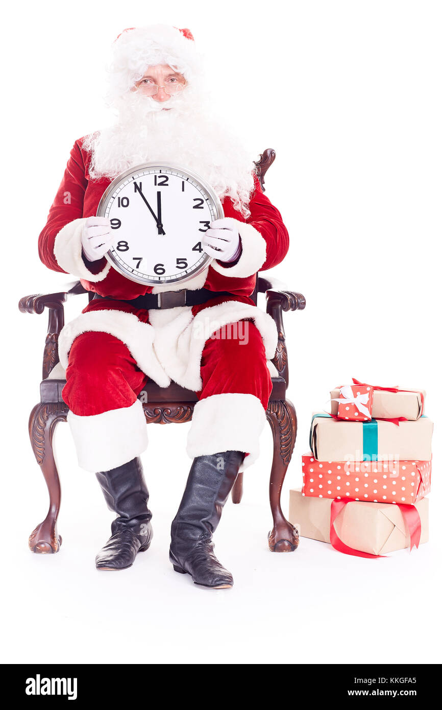 Santa Claus holding clock Stock Photo - Alamy