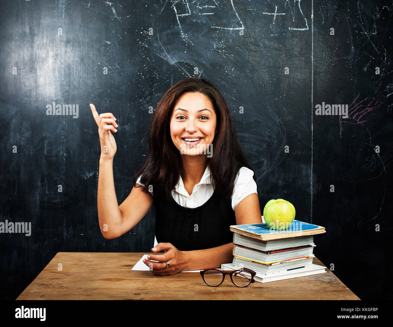 portrait of happy cute real teen student in classroom at blackboard ...