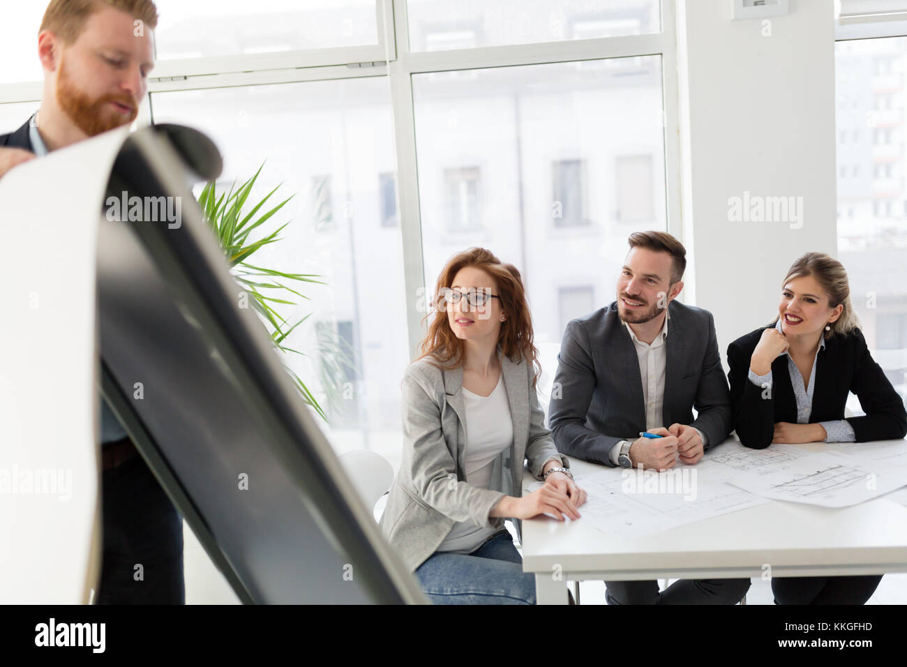 Team of architects working together on project Stock Photo - Alamy