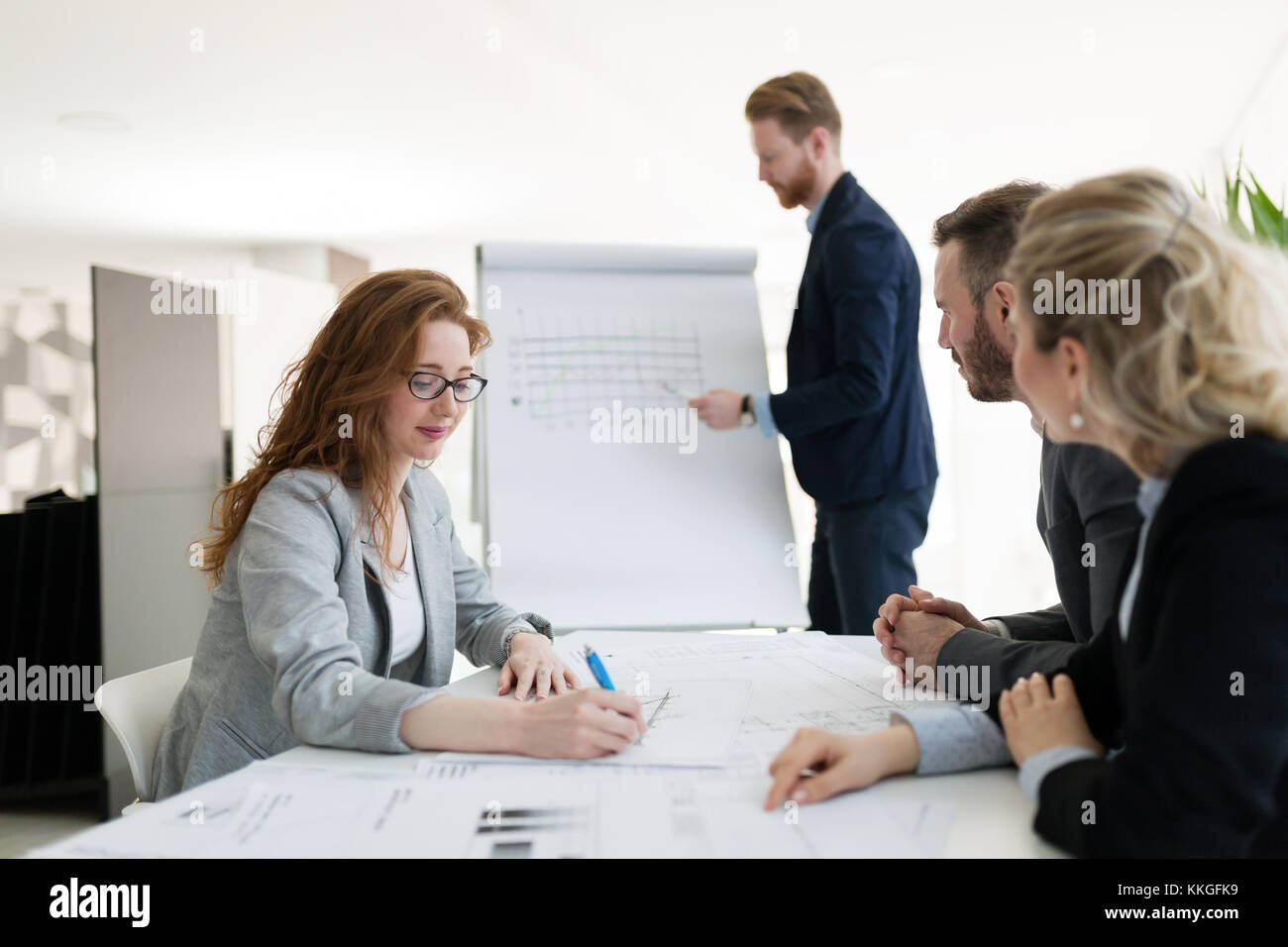 Team of architects working together on project Stock Photo - Alamy