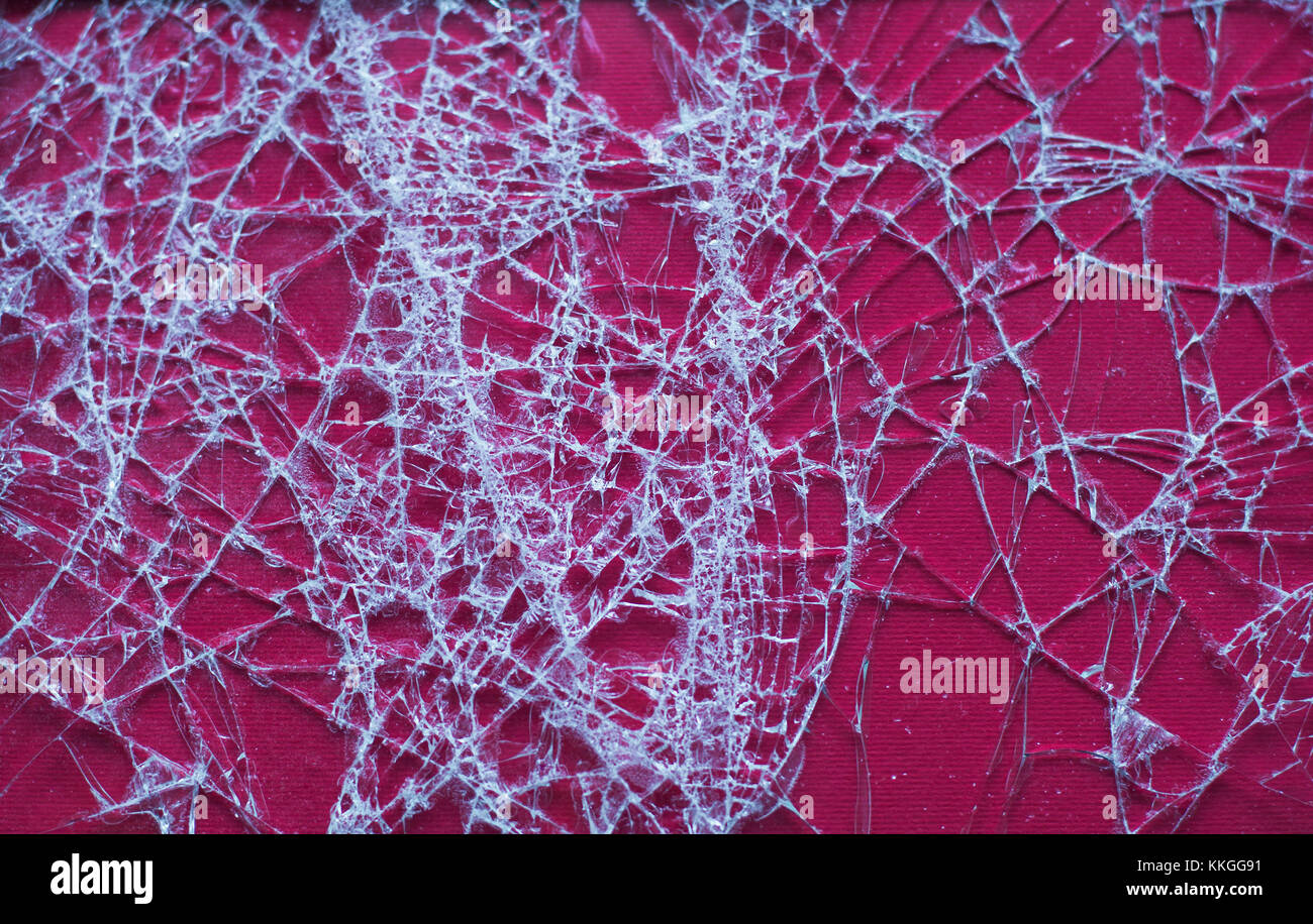 Cracked glass on a red background, background, texture. Broken glass ...