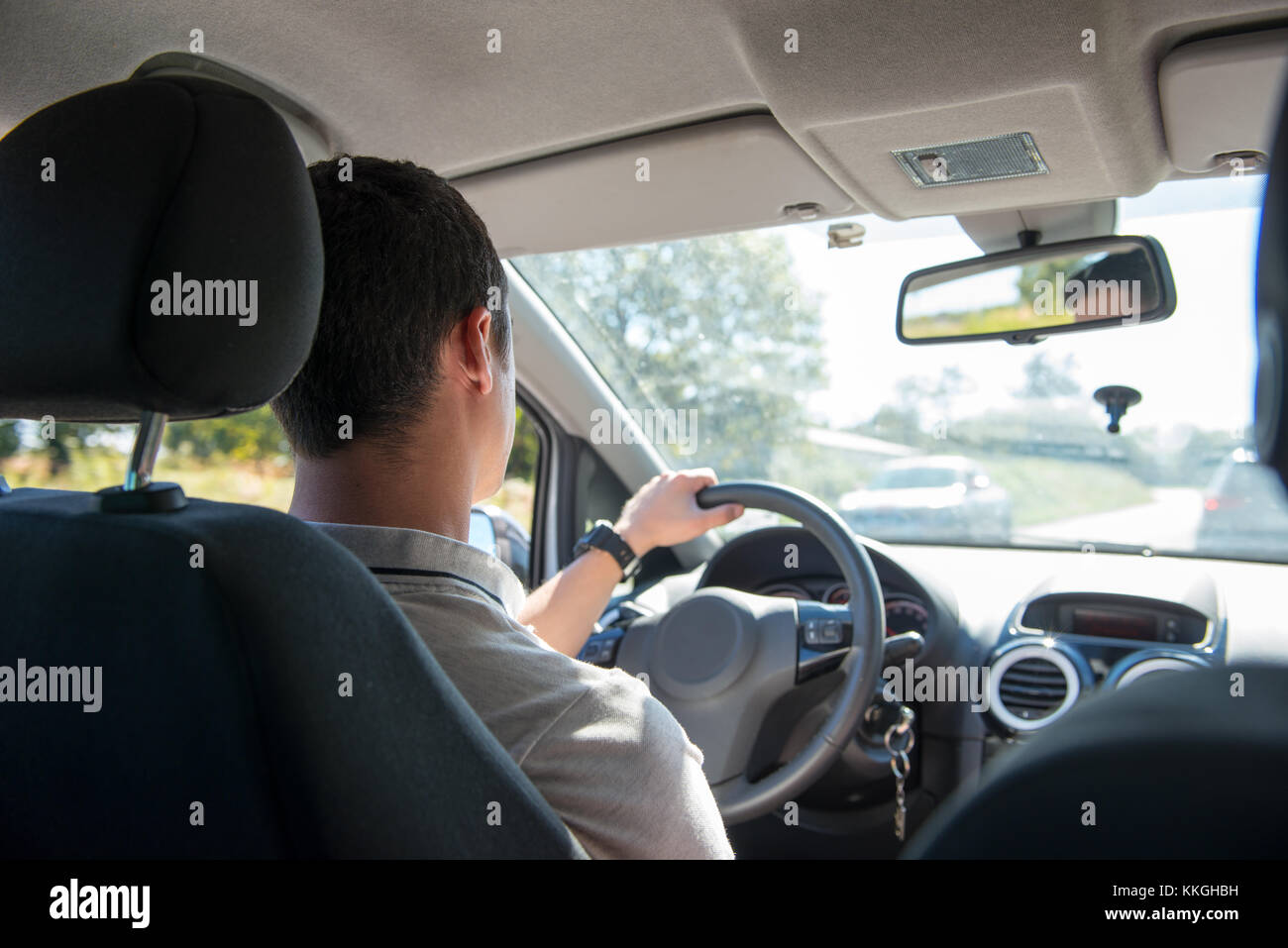 a young man driving a car, back view Stock Photo - Alamy