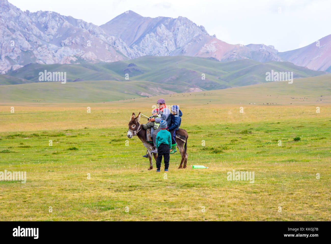 SONG KUL, KYRGYZSTAN - AUGUST 10: Man and three kids climbing up the ...