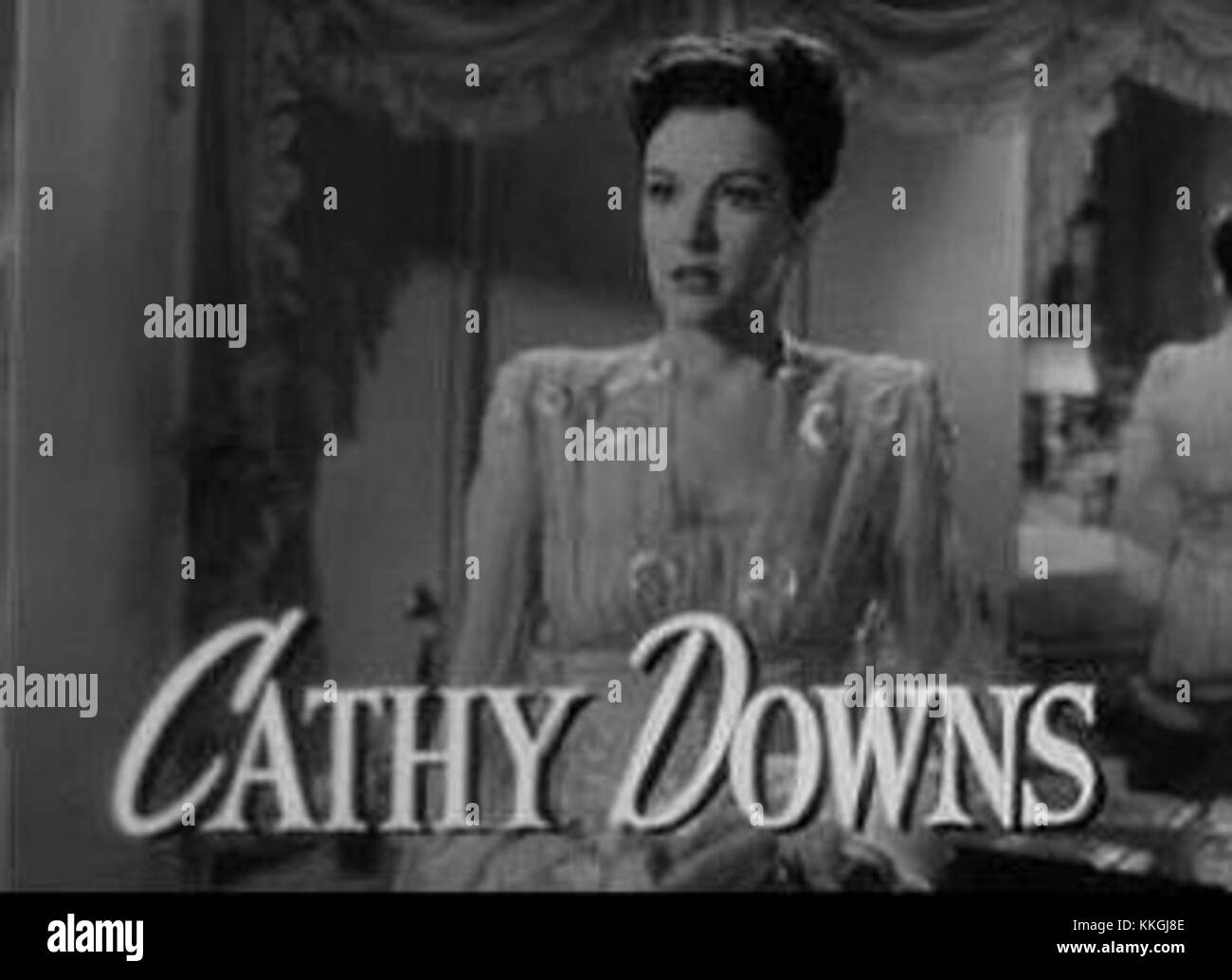 Cathy Downs is featured in a scene from a film, positioned in a dark ...