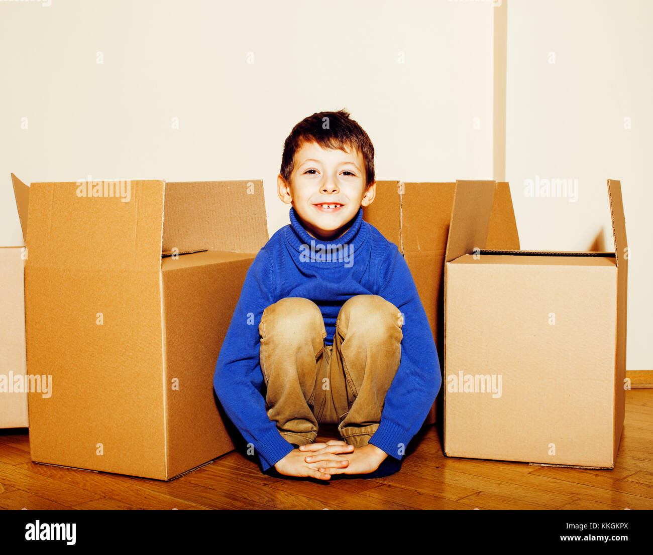 little cute boy in empty room, remoove to new house. home alone emong ...