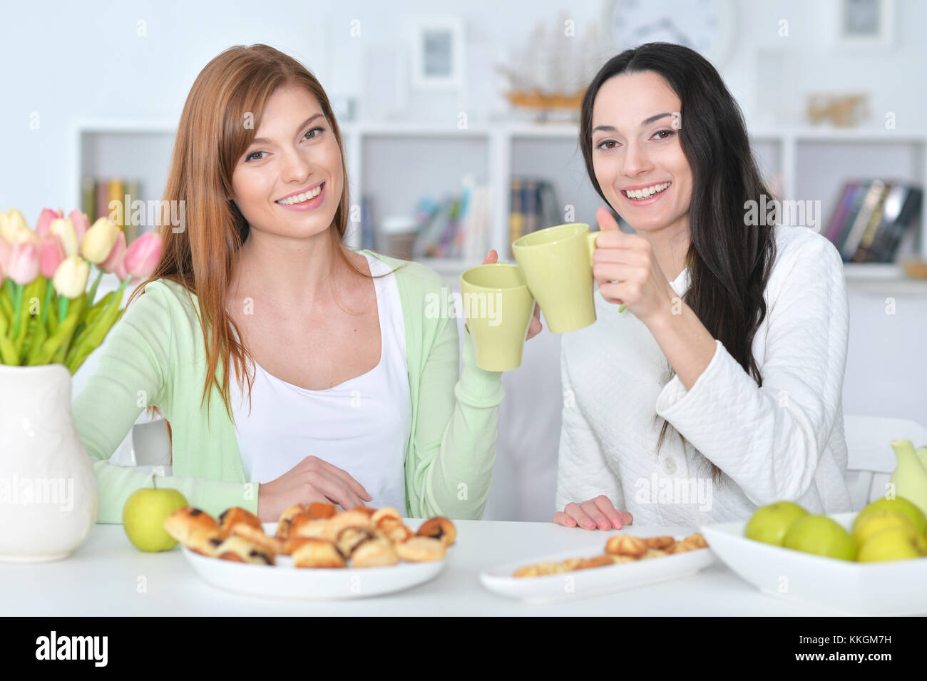 smiling friends drinking tea Stock Photo - Alamy