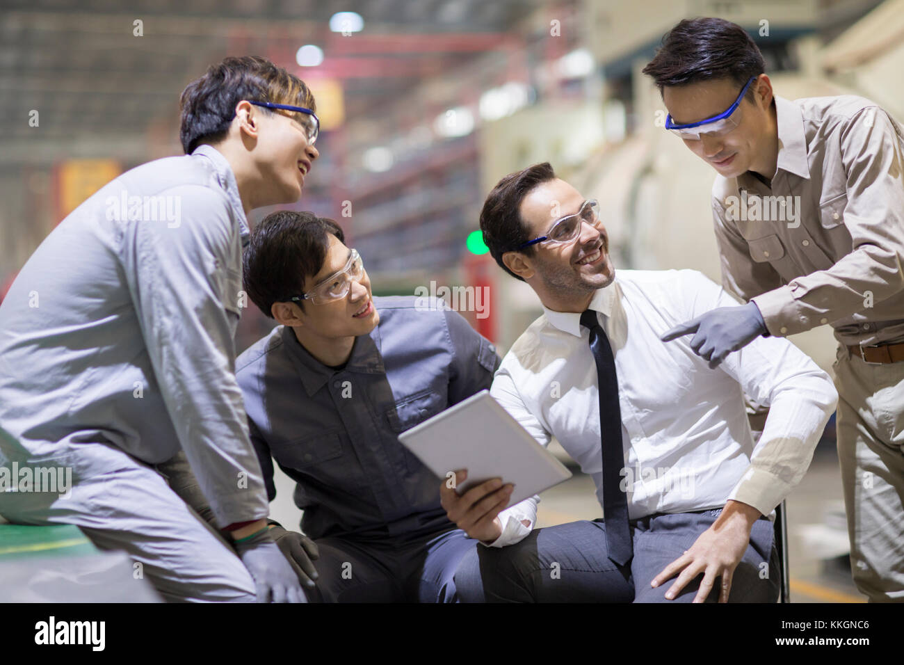 Businessman and engineers talking in the factory Stock Photo - Alamy