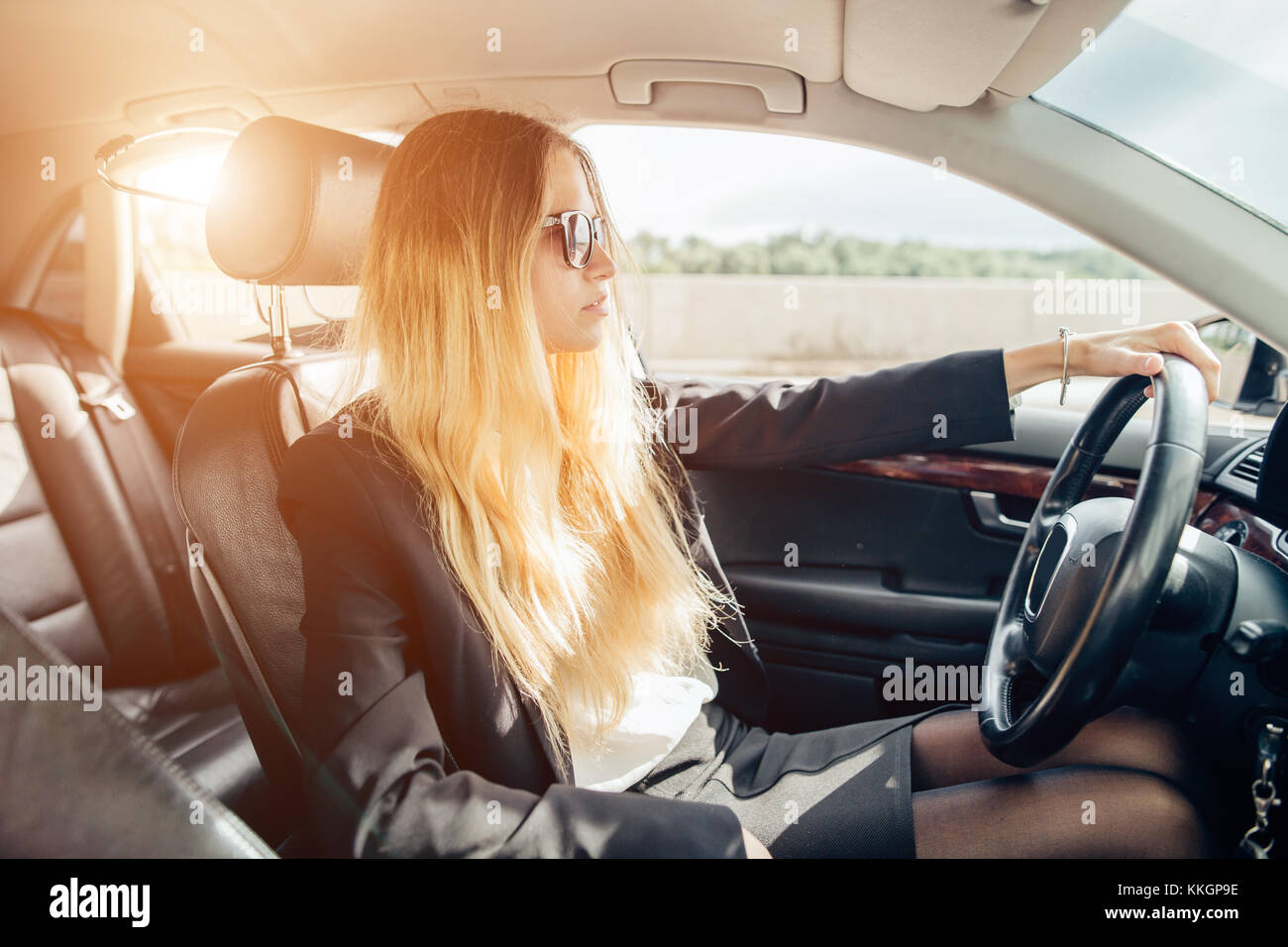 Beautiful happy business woman driving her car Stock Photo - Alamy