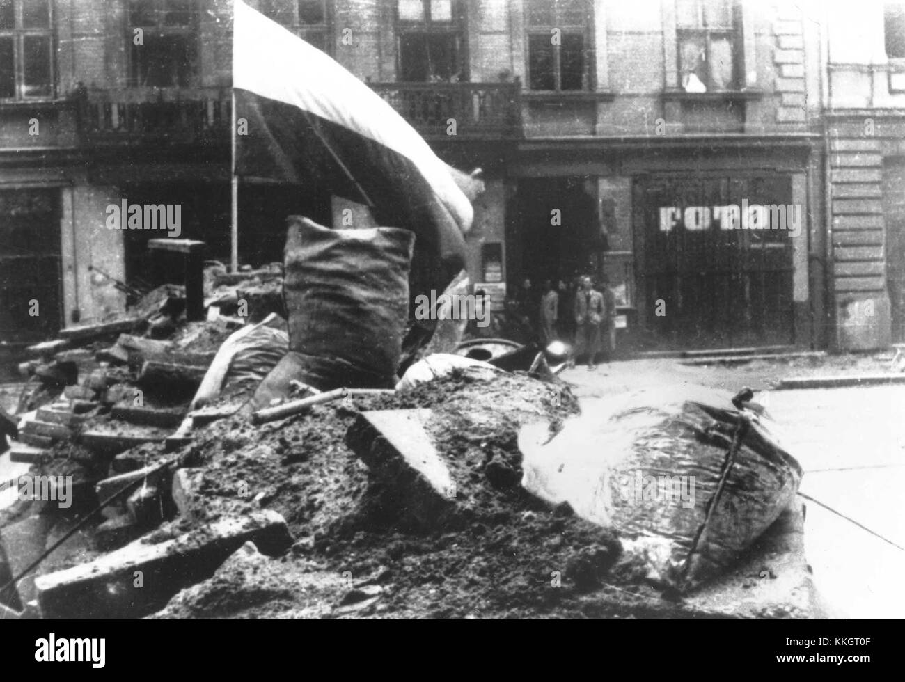 The image shows a barricade and flag from the Warsaw Uprising in 1944 ...