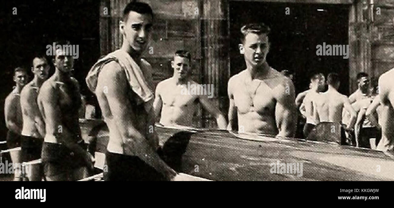 The photograph from 1961 captures a varsity rowing crew transporting a ...