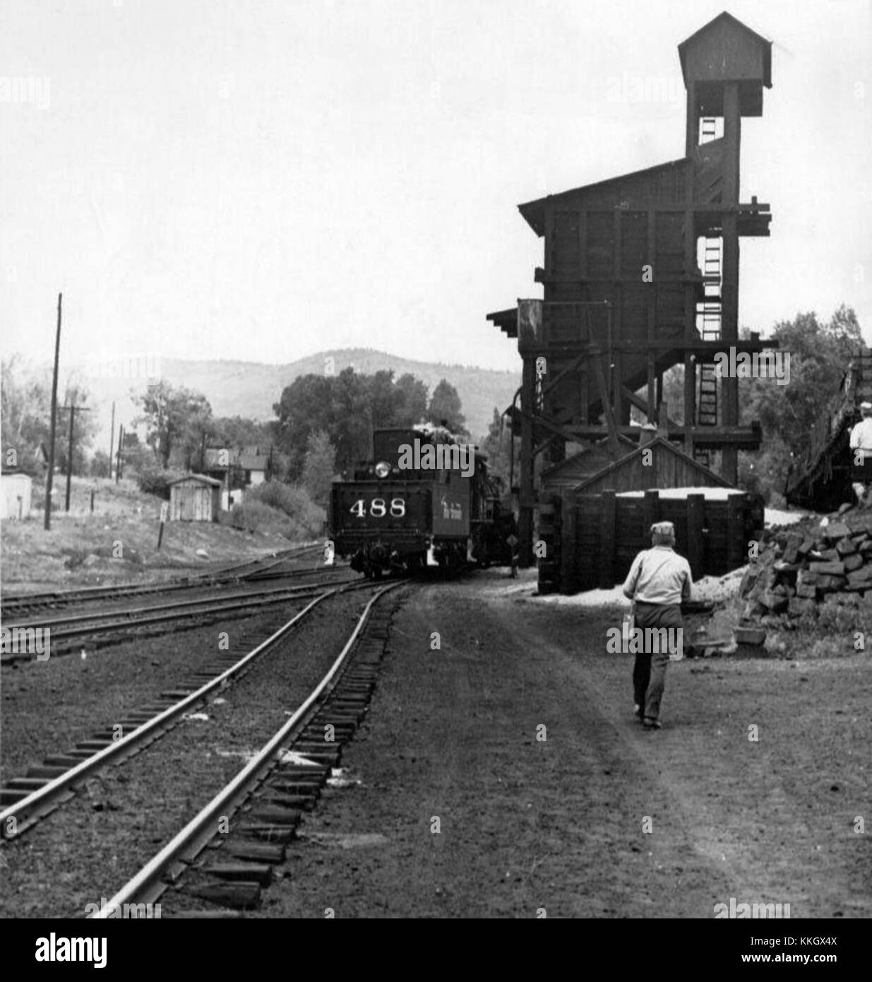This image depicts a Denver and Rio Grande steam locomotive being refueled in 1968, showing the ...