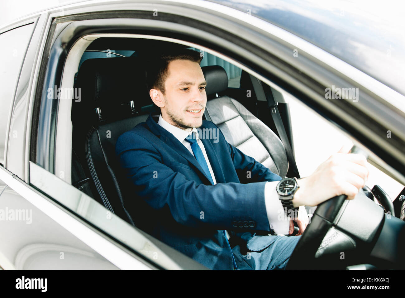Handsome elegant serious man drives a car Stock Photo - Alamy