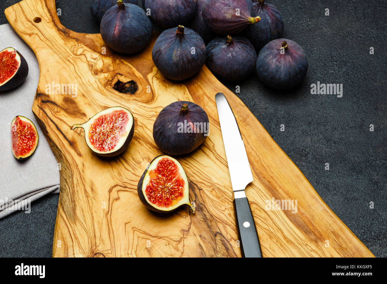 Fig isolated on dark concrete background Stock Photo - Alamy