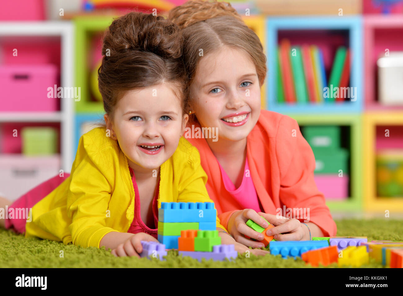 girls playing with colorful blocks Stock Photo - Alamy
