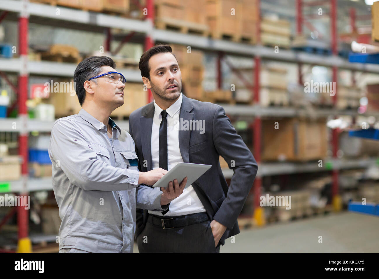Businessman and engineer talking in the factory Stock Photo - Alamy