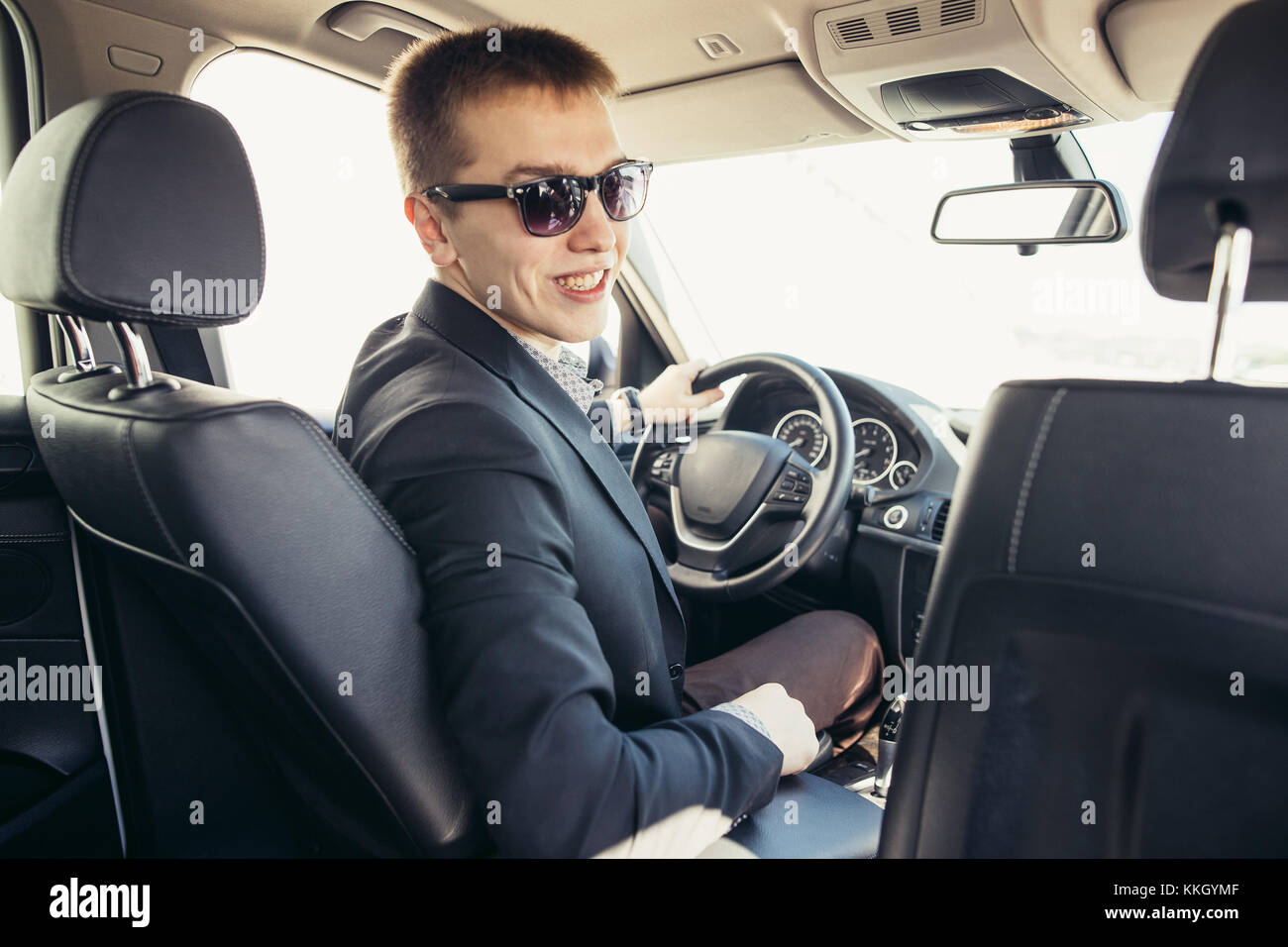 Handsome elegant serious man drives a car Stock Photo - Alamy